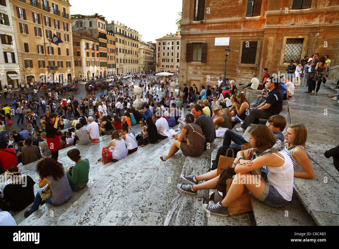 Tourists sat on the Spanish Steps above the Piazza di Spagna in Rome ...