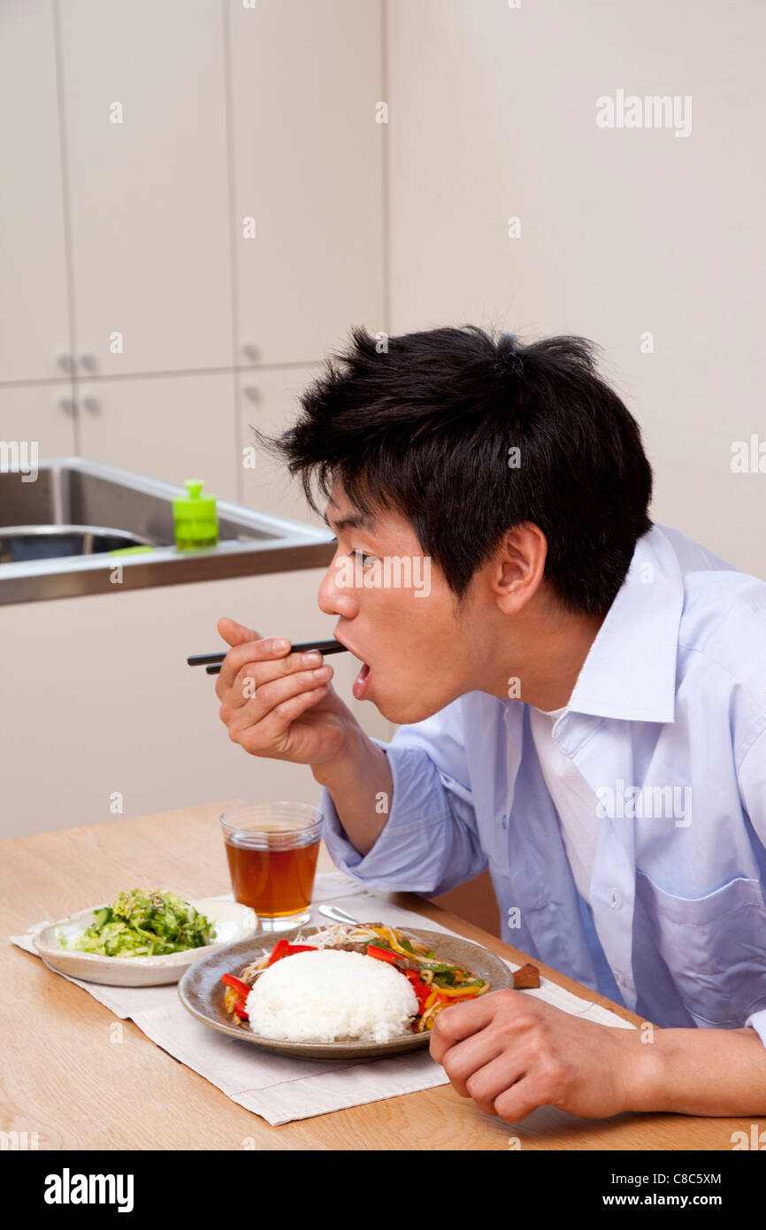 Mid adult man eating pepper steak Stock Photo - Alamy