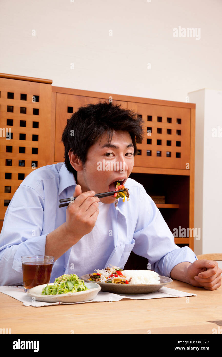 Mid adult man eating pepper steak Stock Photo - Alamy