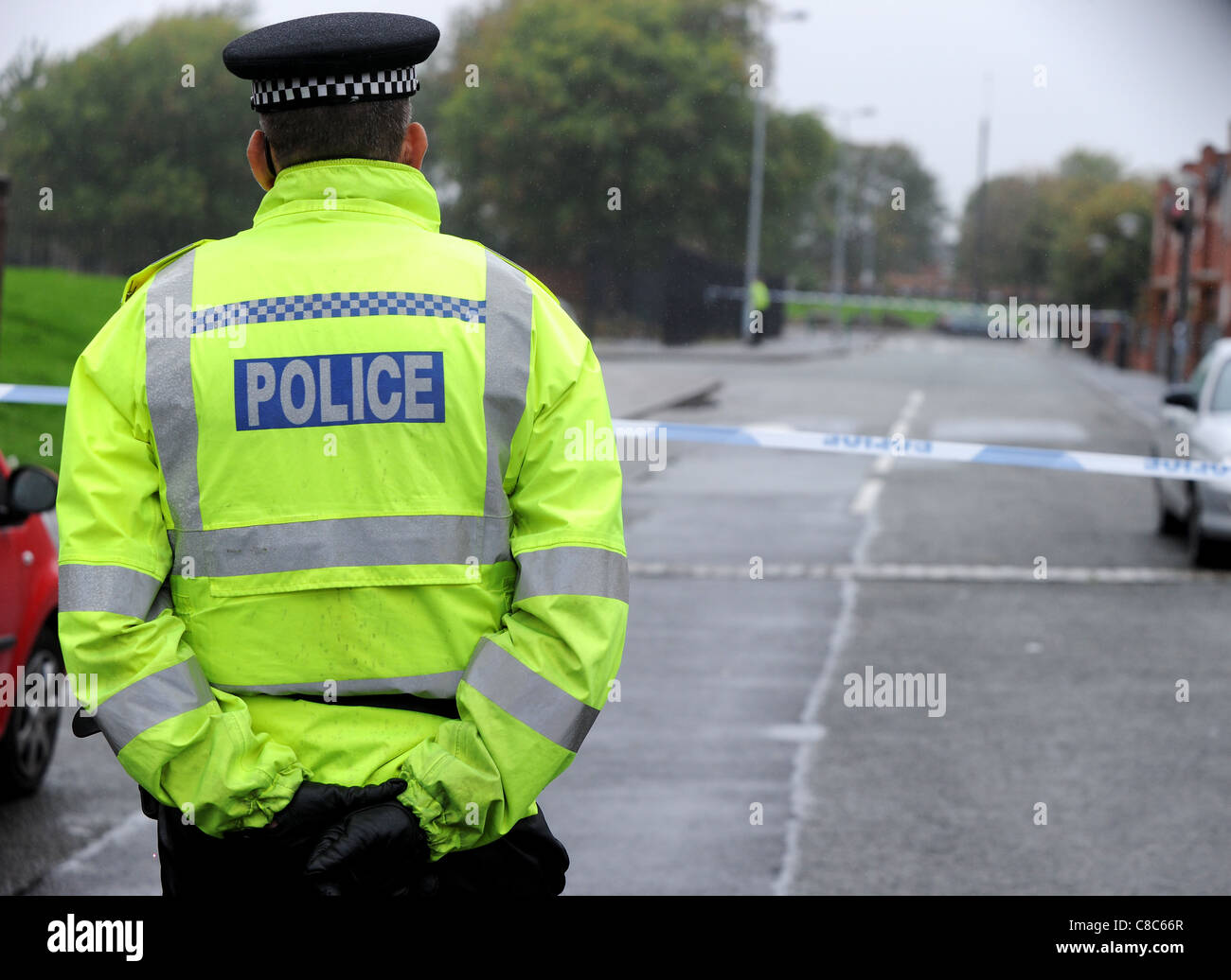 Policeman at the scene of a shooting incident in Salford, Greater ...