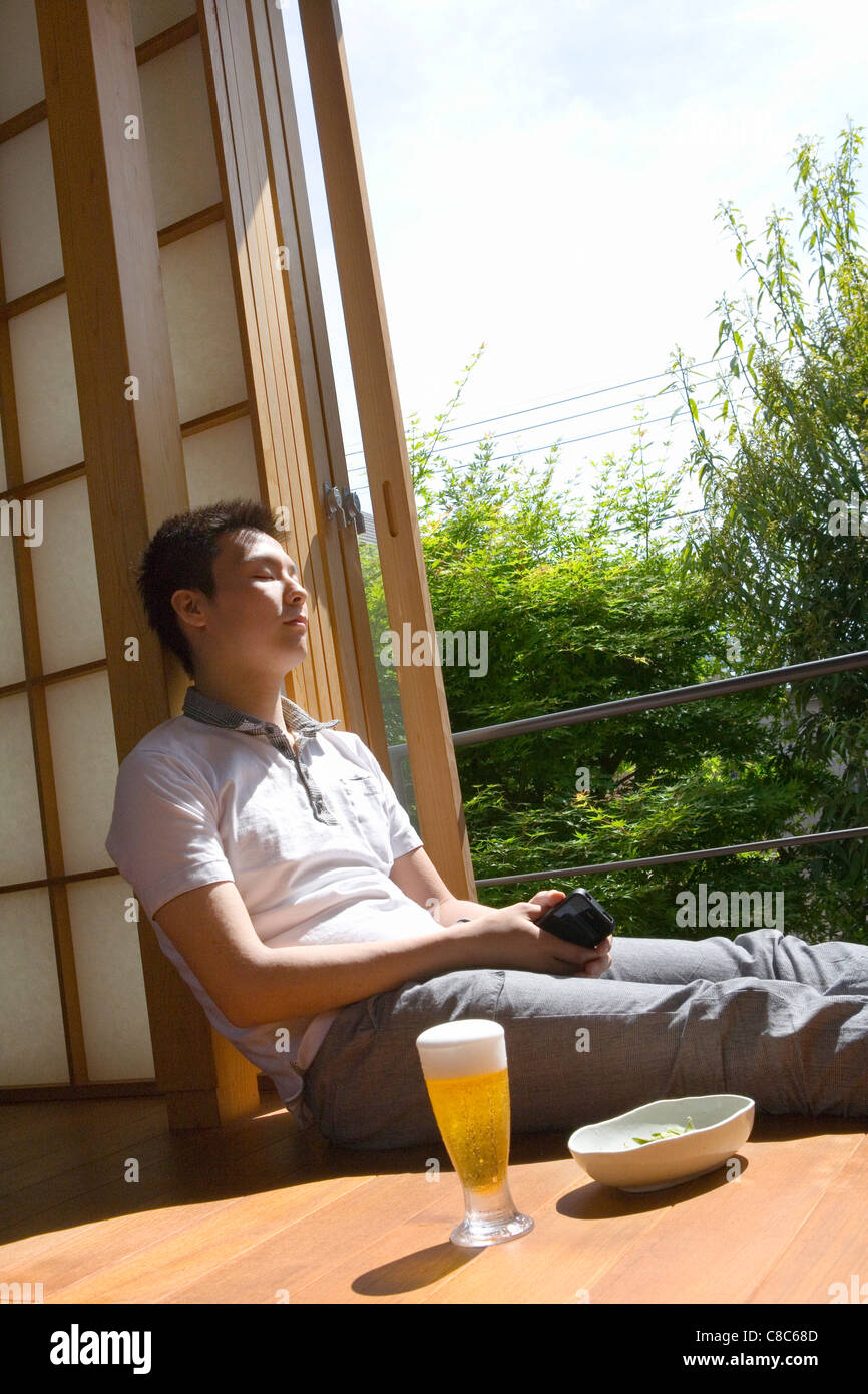 Young man napping by the window Stock Photo - Alamy