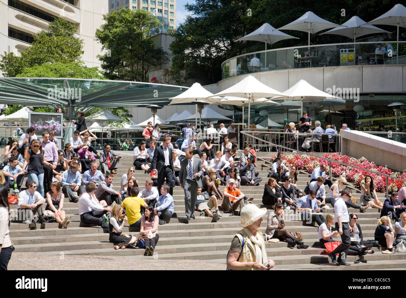 office workers sitting outside in sydney enjoying the summer weather ...