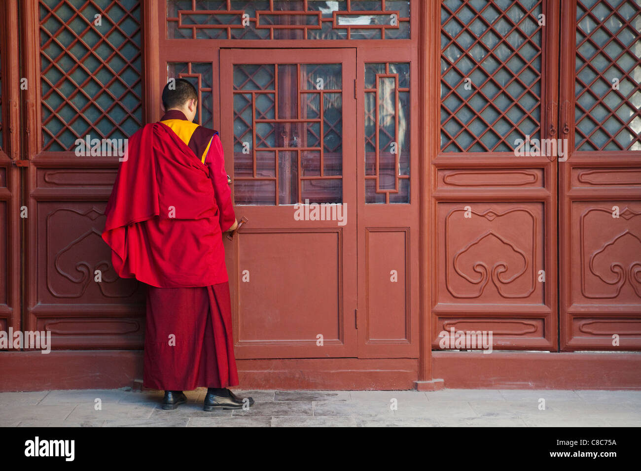 Buddhist monk opening temple door hi-res stock photography and images ...