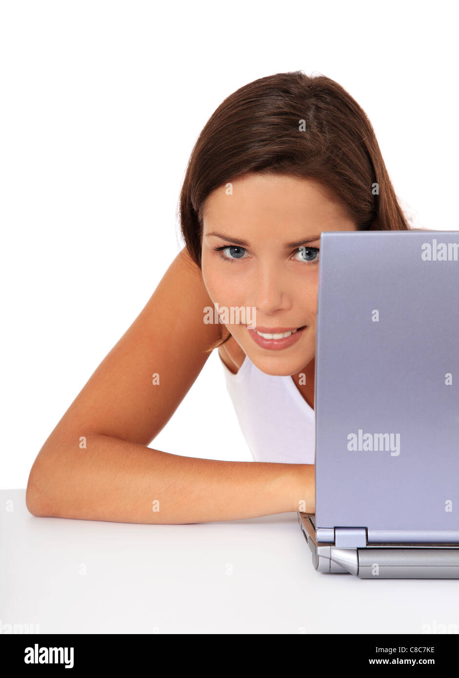 Attractive young woman hiding behind laptop. All on white background ...