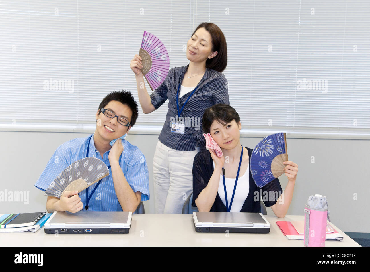 Boss and staffs waving fan at office Stock Photo - Alamy