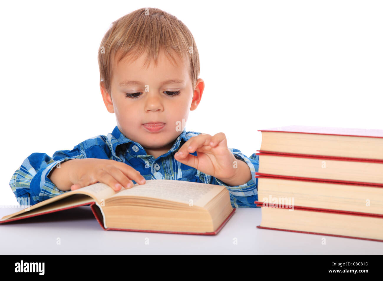 Cute caucasian boy looking through a book. All on white background ...