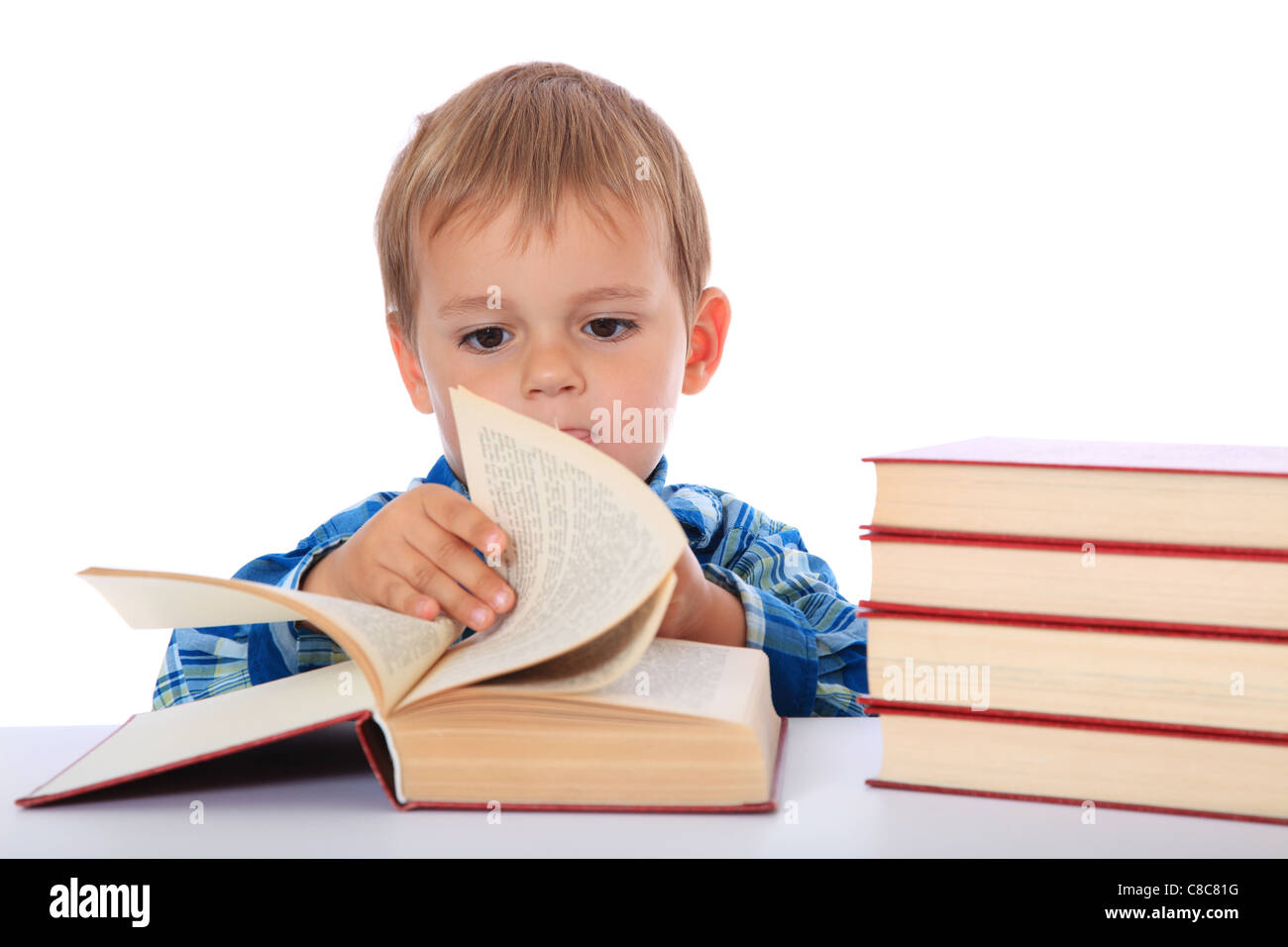 Cute caucasian boy looking through a book. All on white background ...