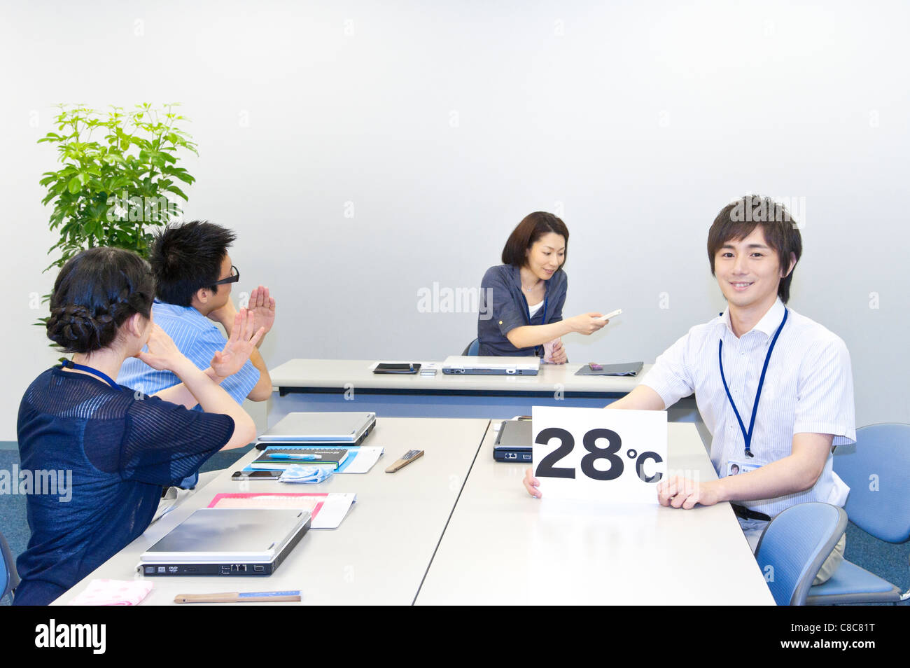 Staffs stopping boss changing temperature of air conditioner Stock ...