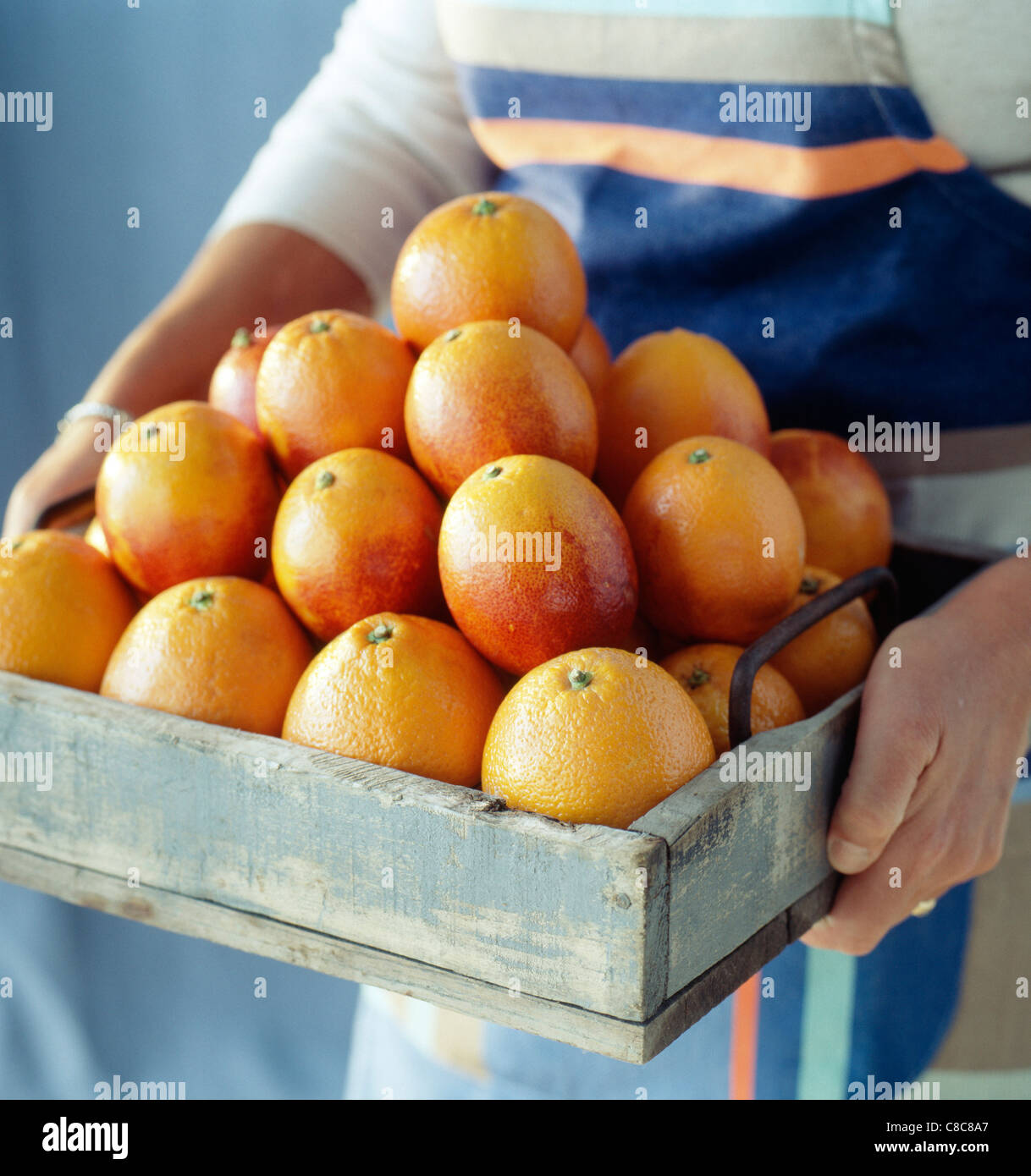 tray of stacked oranges and person Stock Photo - Alamy