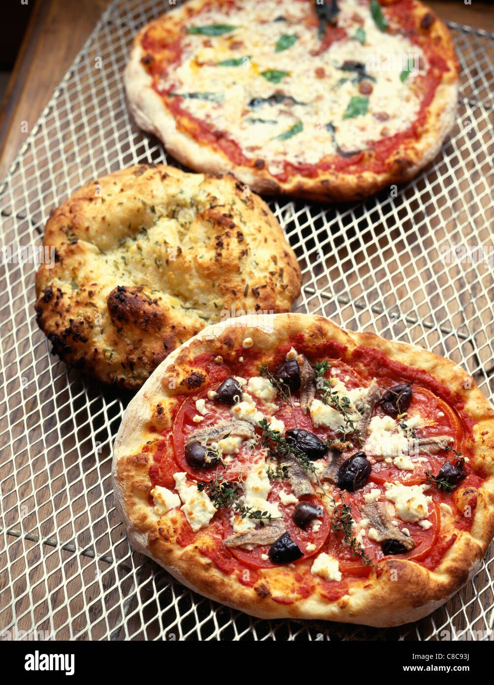 Selection of pizzas on a grill Stock Photo - Alamy
