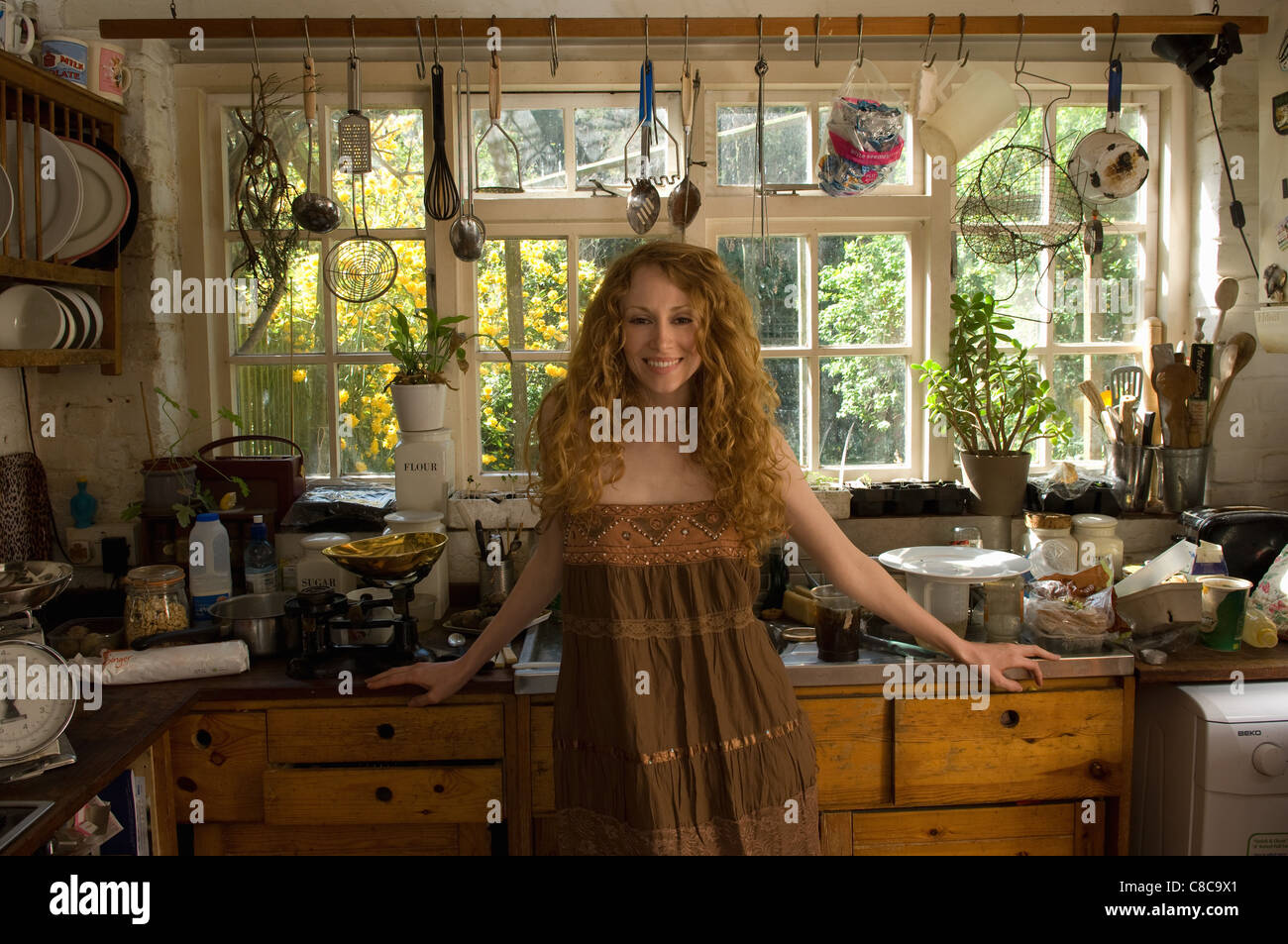 Woman standing in kitchen Stock Photo - Alamy