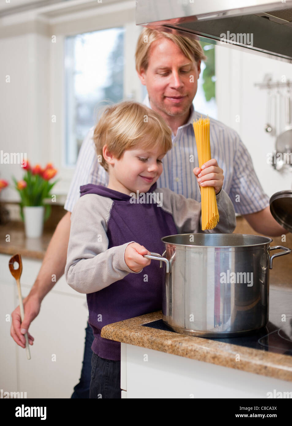 Father and son cooking together Stock Photo - Alamy