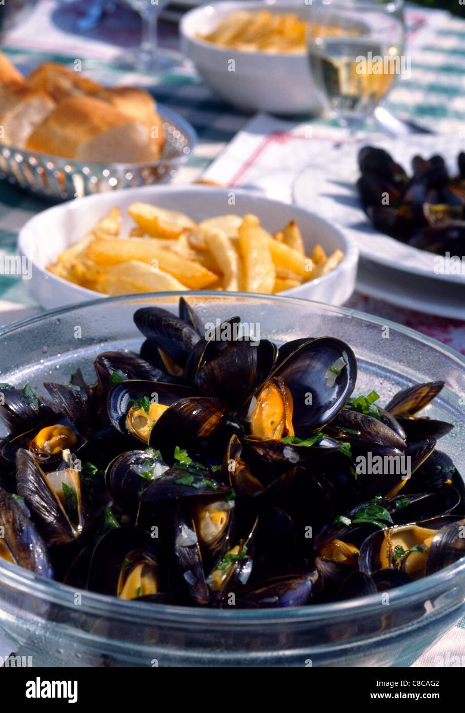 Mussels and chips on table outdoors Stock Photo - Alamy