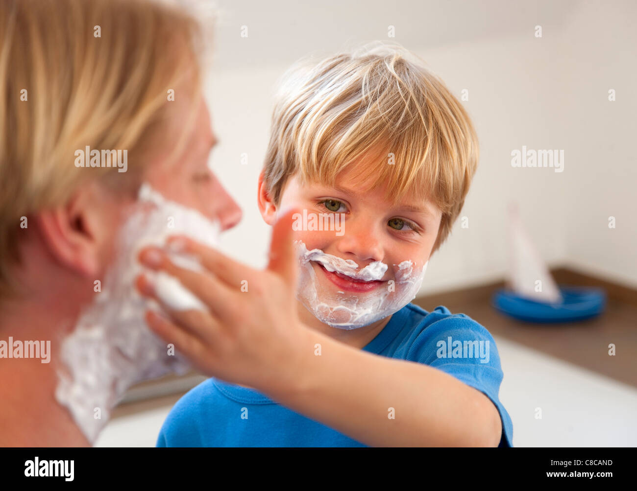 Father and son applying shaving cream Stock Photo - Alamy