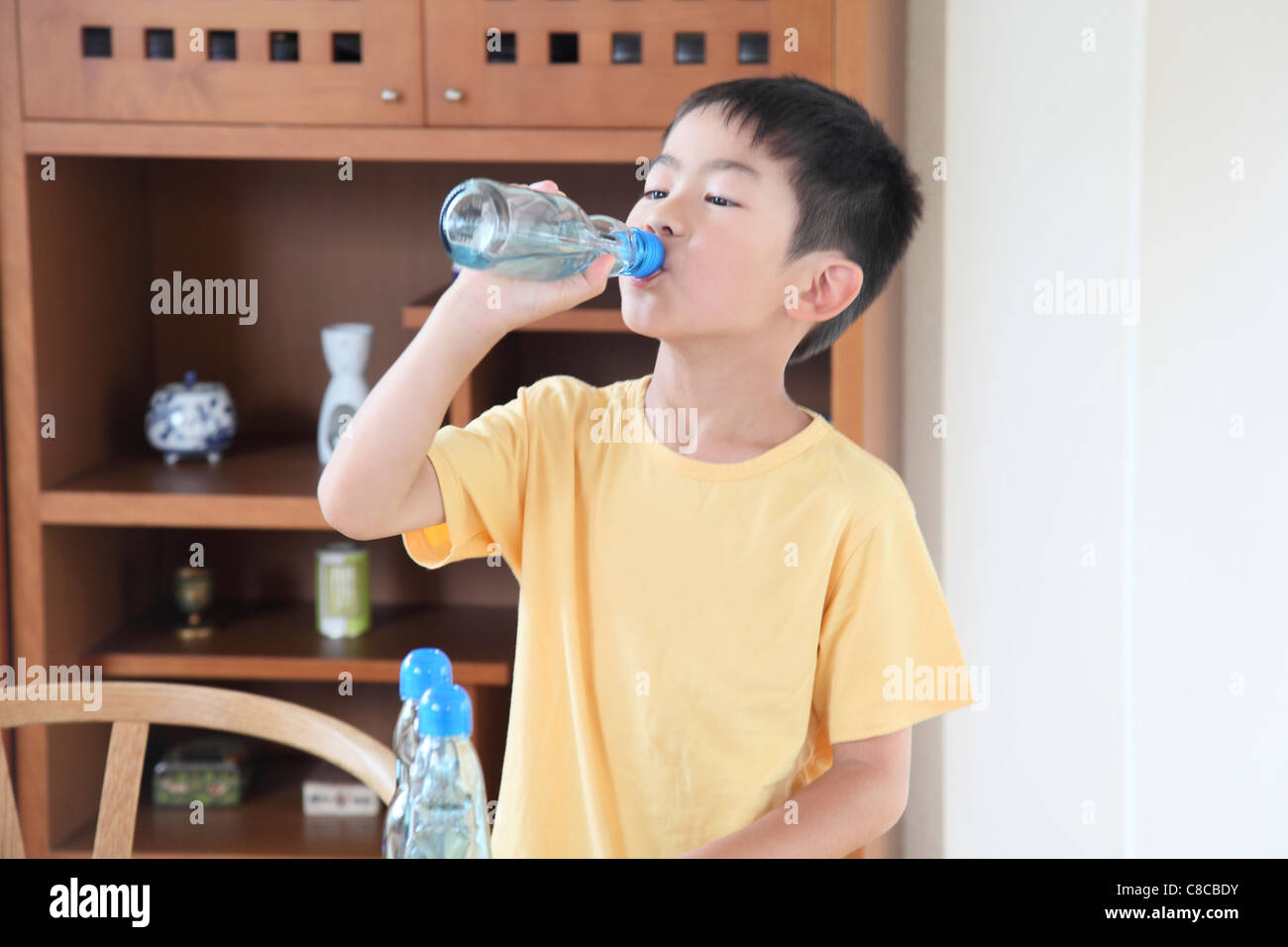 Boy drinking soda from bottle Stock Photo - Alamy