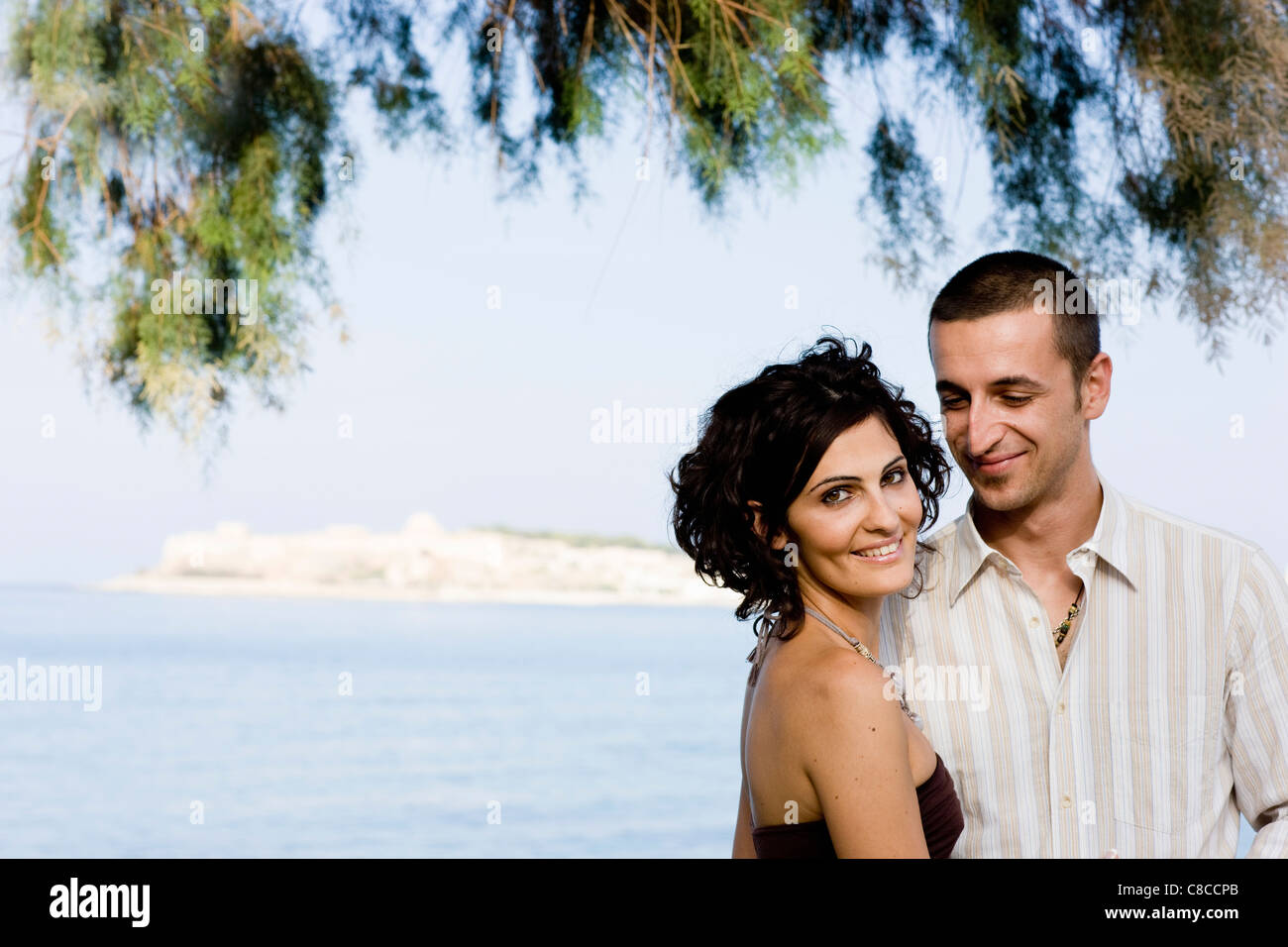 Couple smiling together on waterfront Stock Photo - Alamy