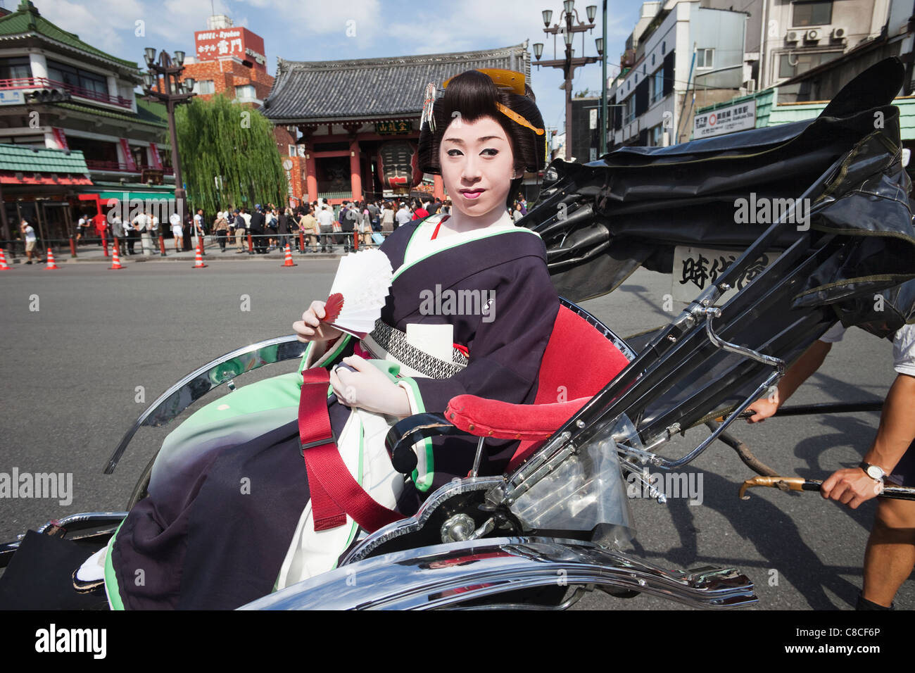 Japan, Tokyo, Asakusa, Geisha in Rickshaw in front of Asakusa Kannon ...