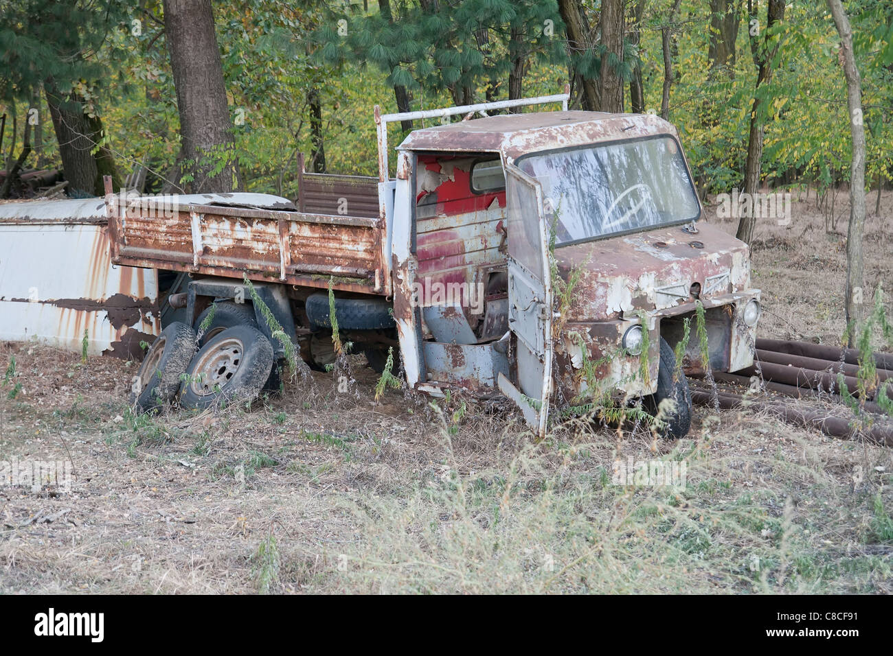 Old rusty three-wheeler abandoned in a rural place Stock Photo - Alamy