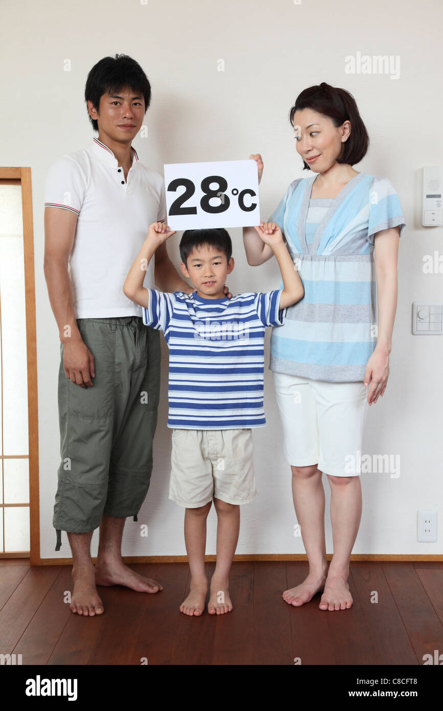 Family holding board of saving electricity Stock Photo - Alamy