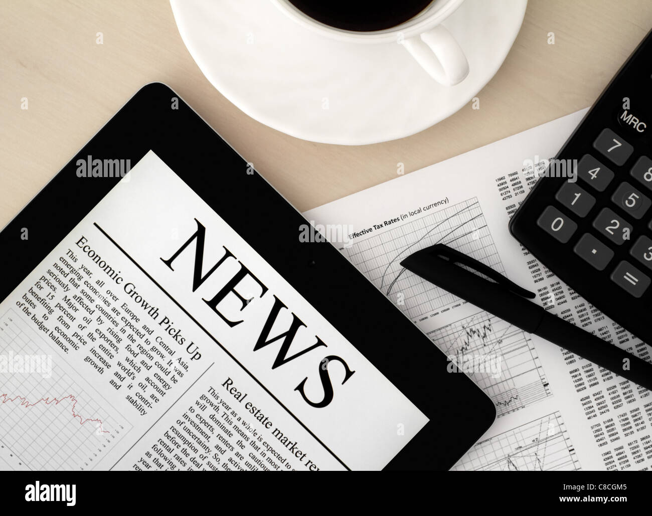Desktop with a Tablet PC, which shows the latest news on screen Stock ...