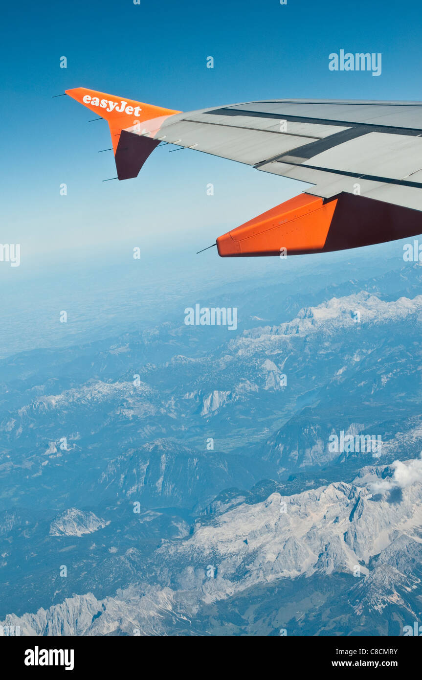 Wing of an airplane flying over alps hi-res stock photography and ...