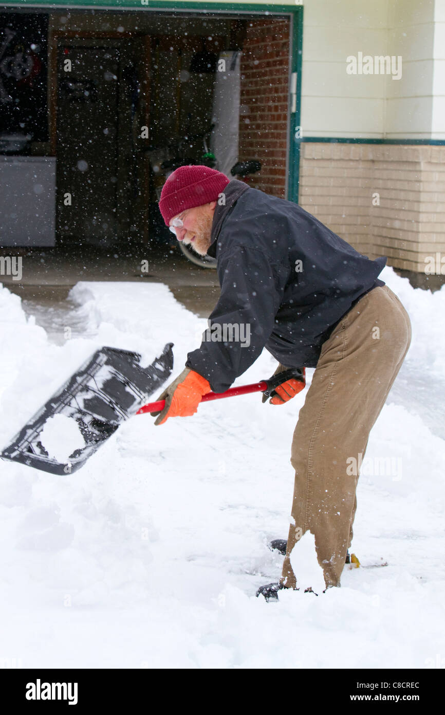 Man shoveling winter snow of off a driveway in Boise, Idaho, USA Stock ...