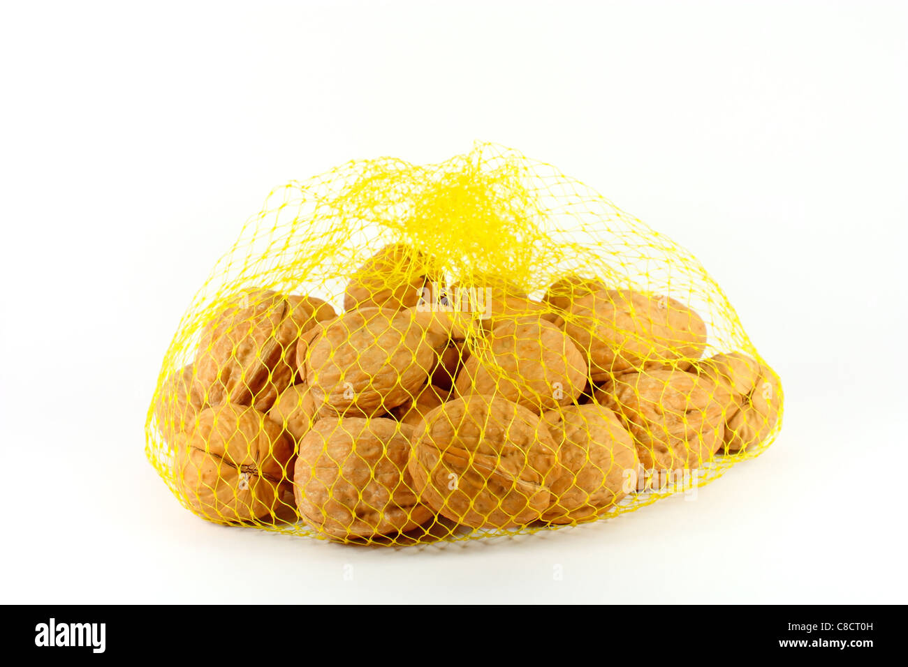 Walnuts in a plastic net isolated on white Stock Photo - Alamy