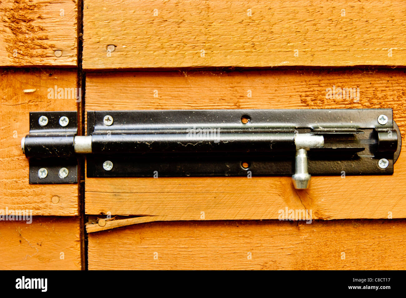 Bolt or latch on a wooden door Stock Photo - Alamy