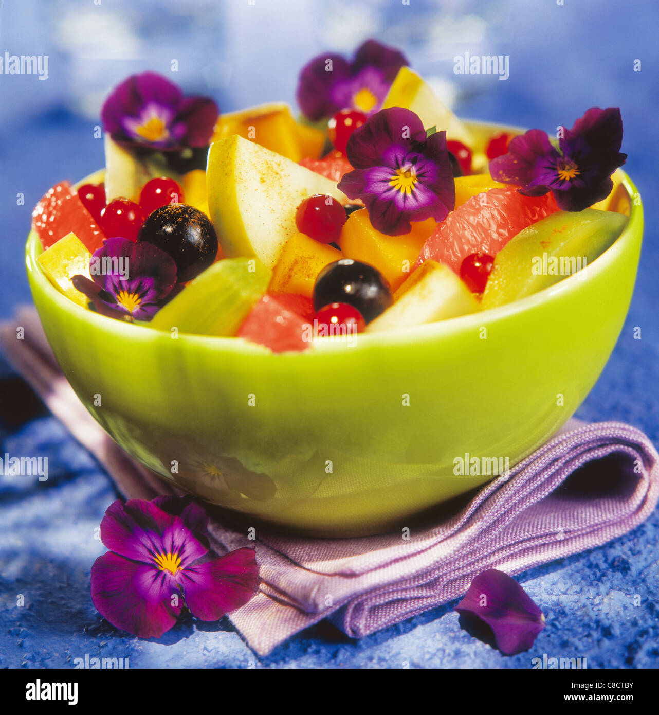 Fruit salad with violets Stock Photo - Alamy