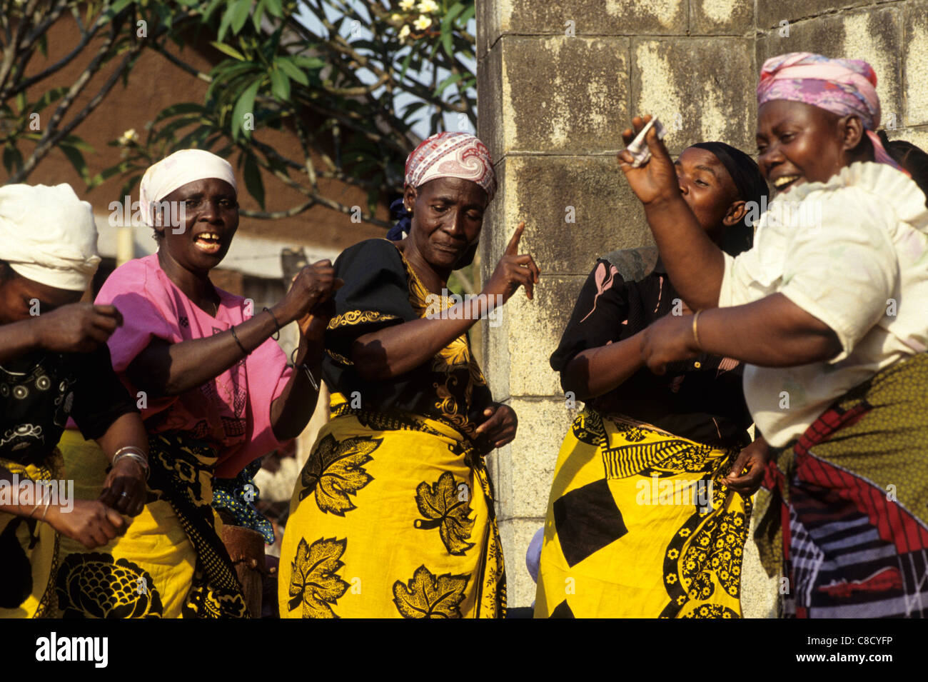 Ujiji, Tanzania. Luba dancers in yellow wraps and headdresses Stock ...