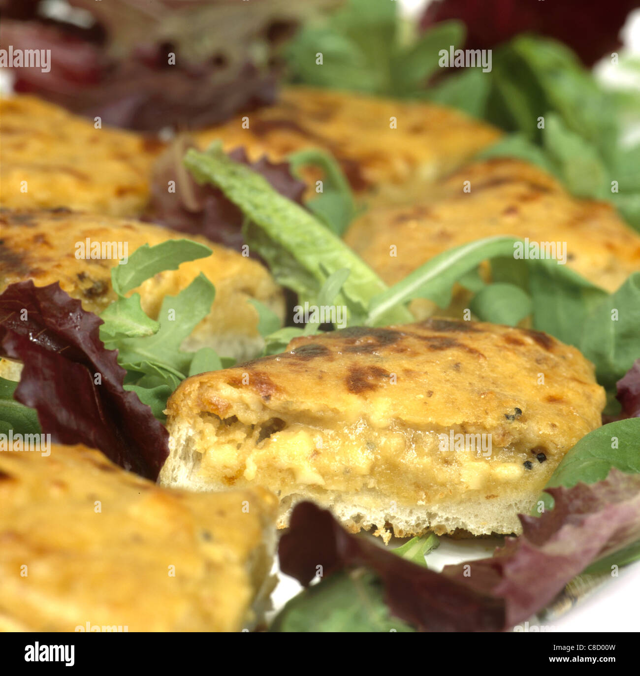 Slices of Welsh rarebit, with salad Stock Photo - Alamy