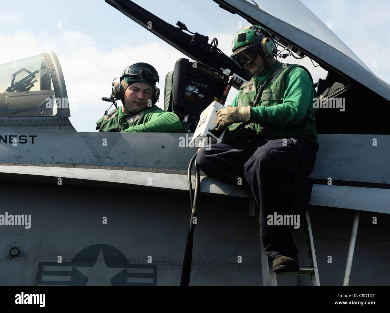 Loading software into an F/A-18C Hornet assigned to the Golden Dragons ...