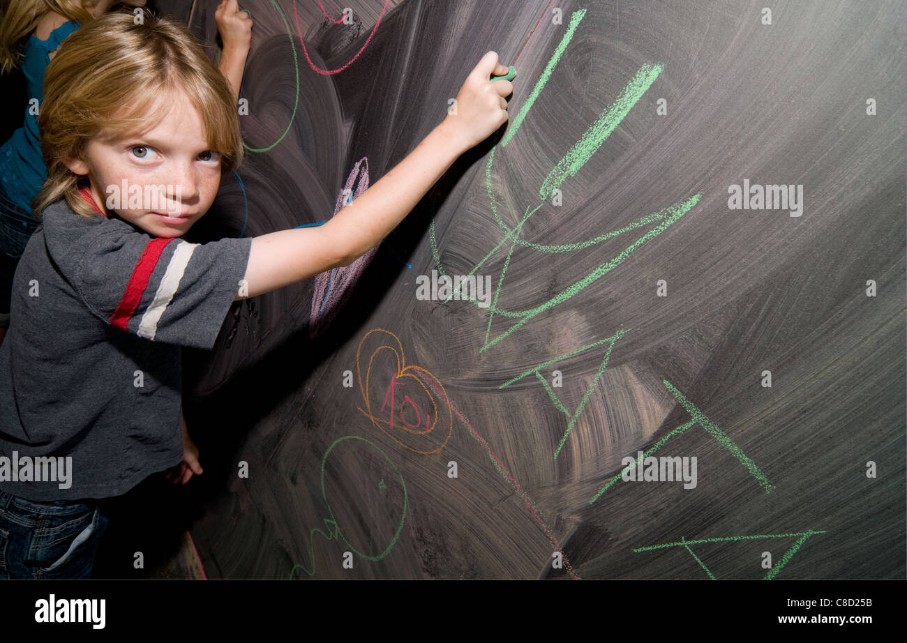 Elementary School Kids Drawing on a Blackboard Stock Photo - Alamy