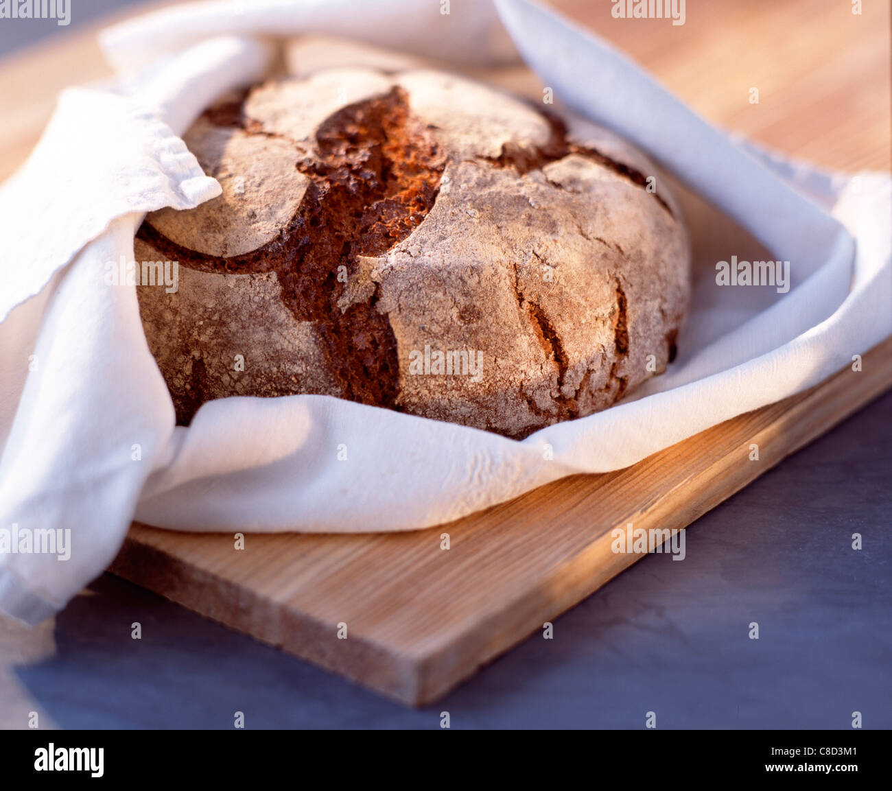 Round loaf of bread wrapped in cloth Stock Photo - Alamy