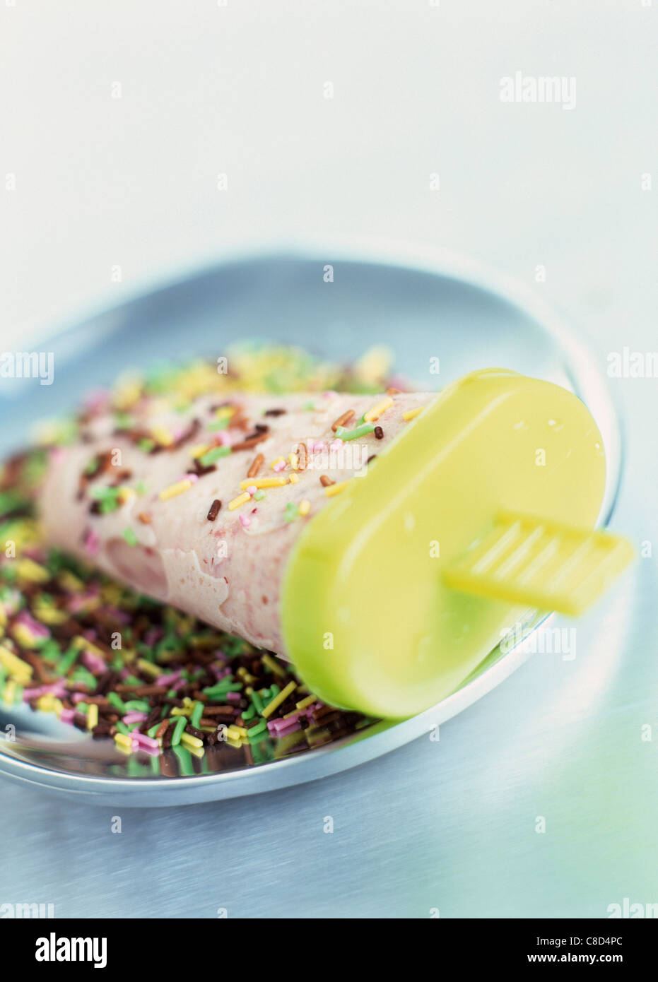 Strawberry ice lolly with colored sugar confetti Stock Photo - Alamy