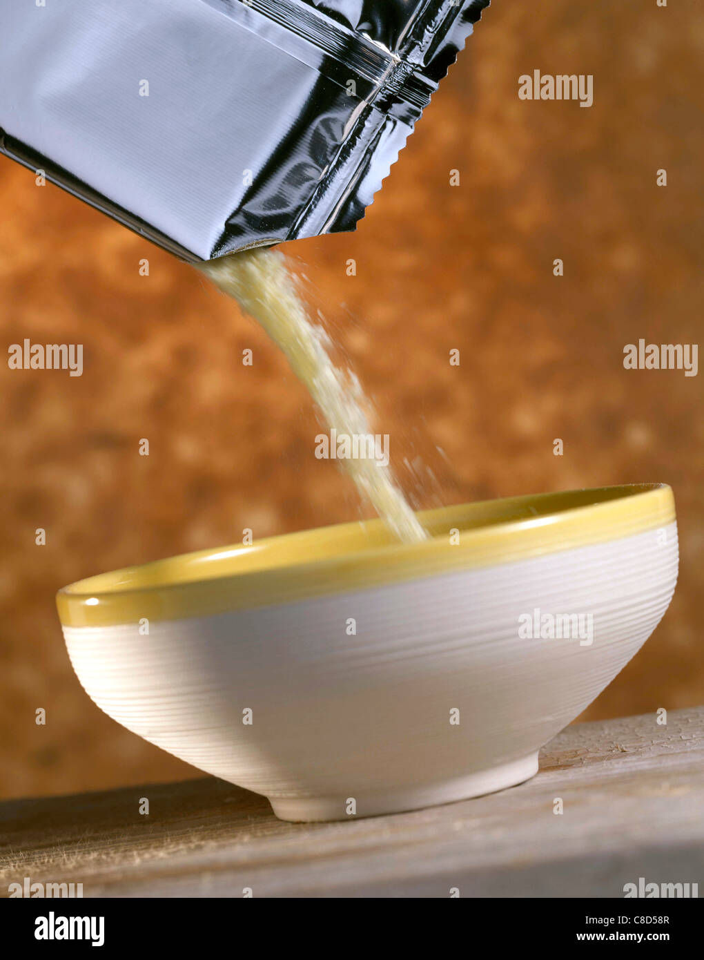 Pouring potato flakes into bowl Stock Photo - Alamy