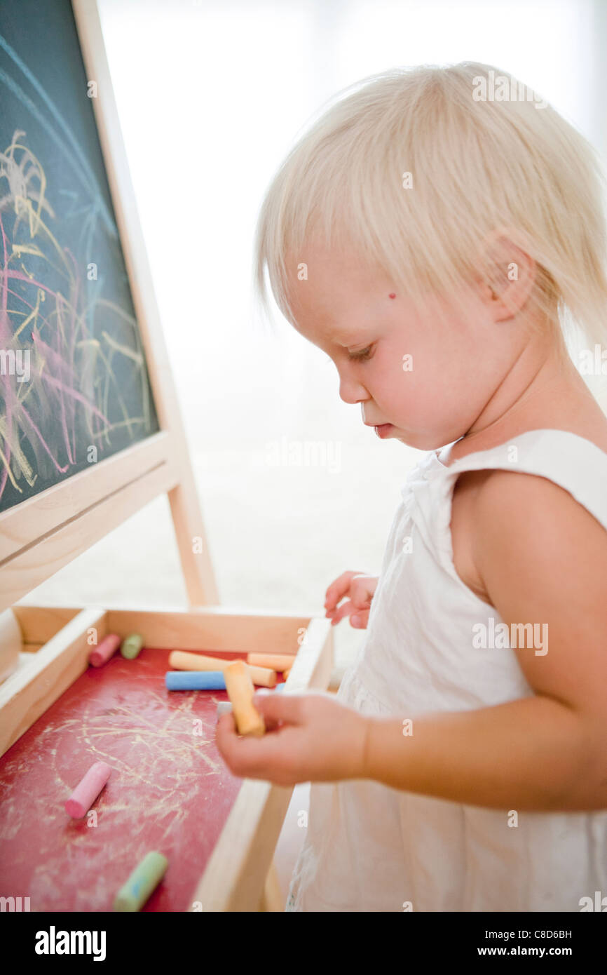 Toddler Girl at Chalkboard Stock Photo - Alamy