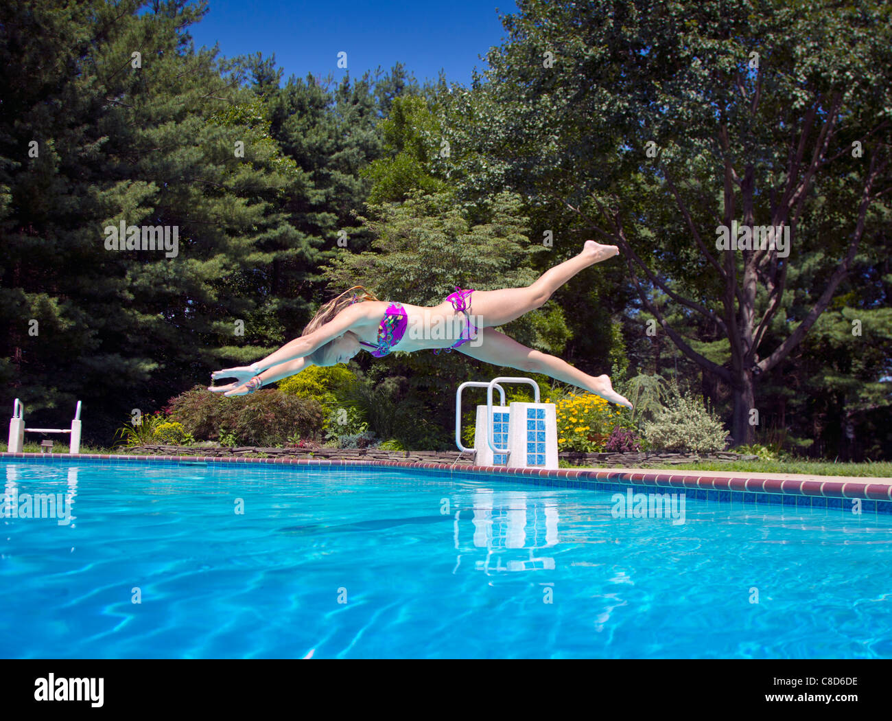 Young girl diving into a swimming pool Stock Photo - Alamy