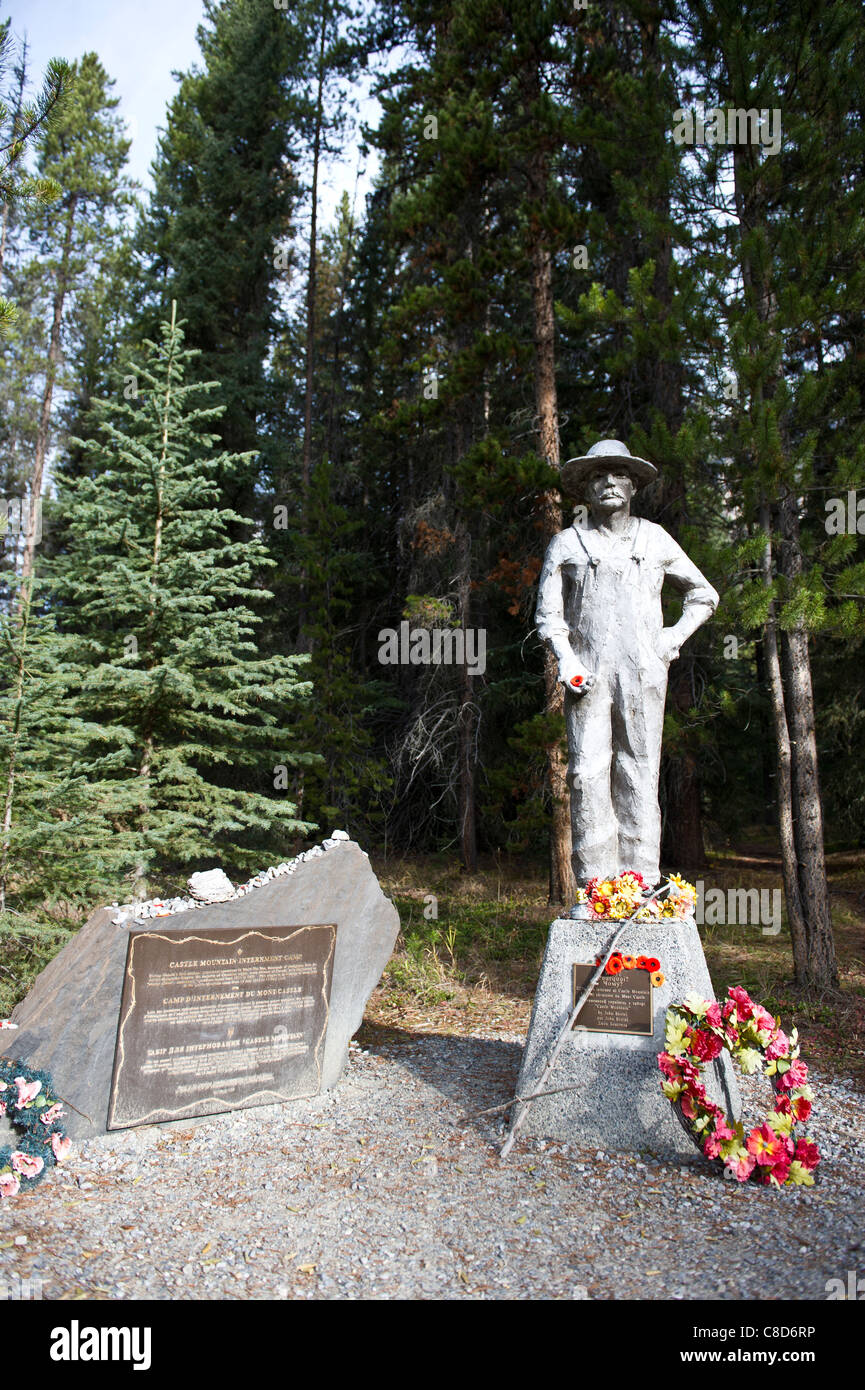 Statue and memorial plaque of a man surrounded by colorful wreaths in a ...
