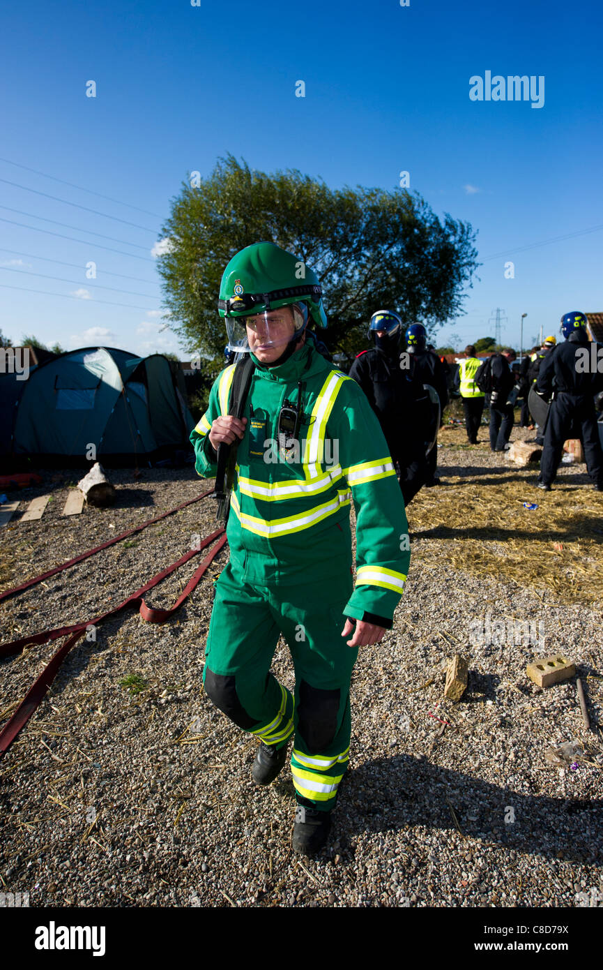 East of England Ambulance Service paramedic wearing helmet walking ...