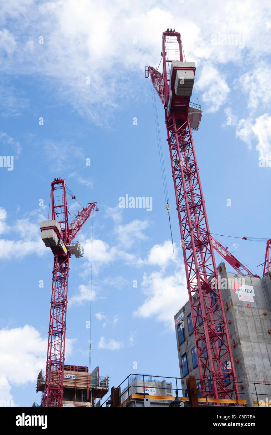 Two red cranes in operation on a building site in London, 2011 Stock ...