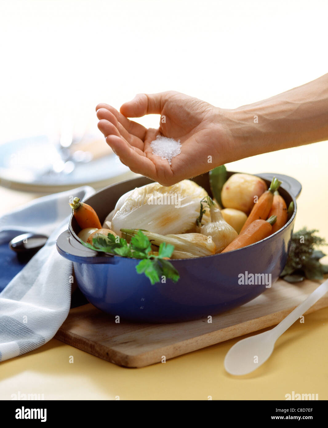 Salting food with hand Stock Photo - Alamy