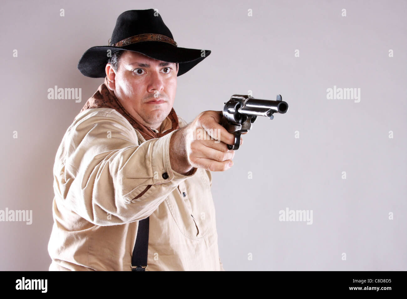 A cowboy pointing a gun Stock Photo - Alamy