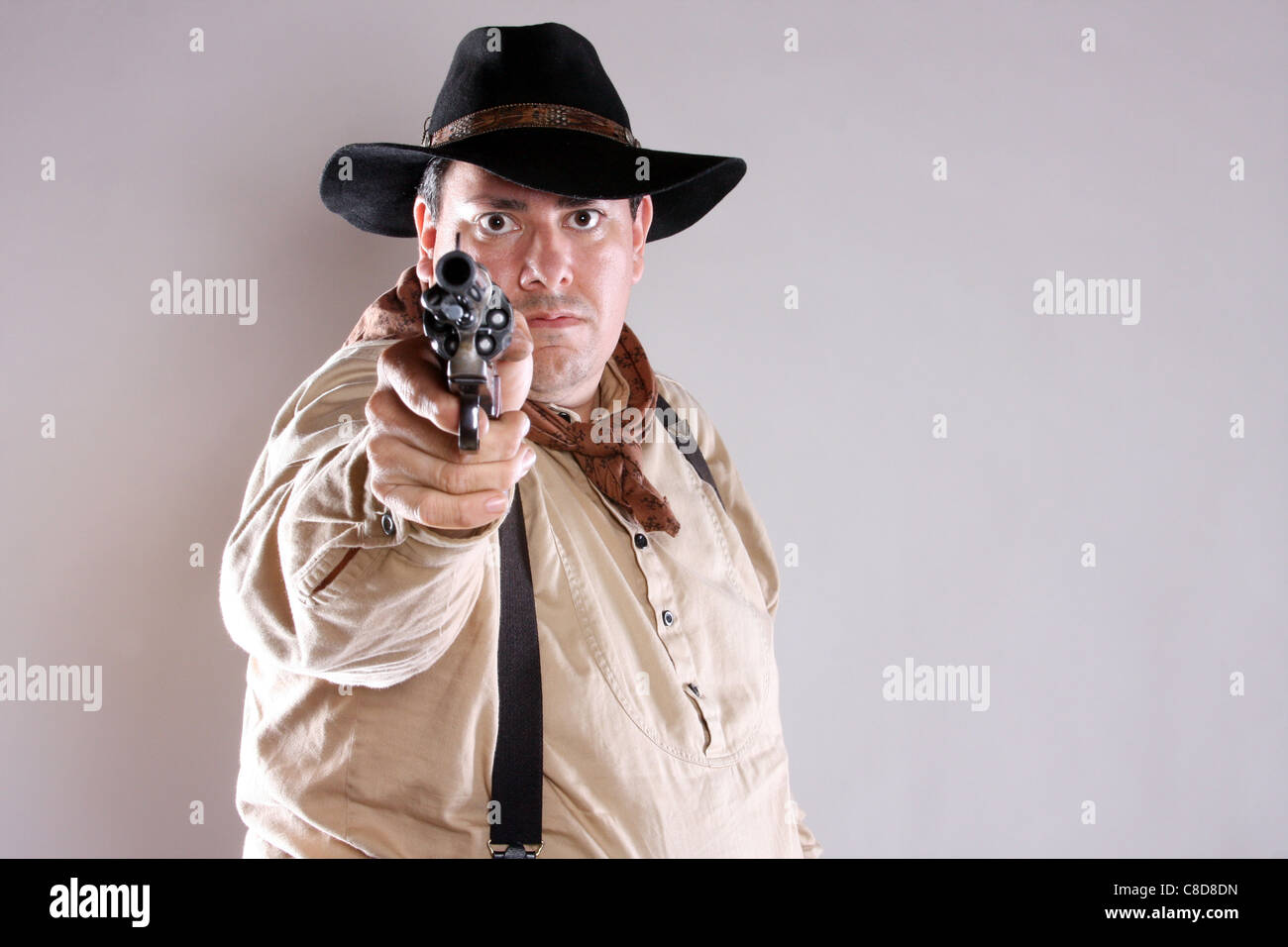 A cowboy pointing a gun Stock Photo - Alamy
