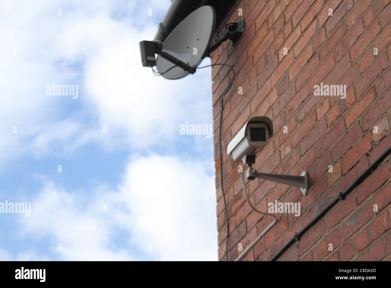 security cameras CCTV cameras on a red brick wall Stock Photo - Alamy