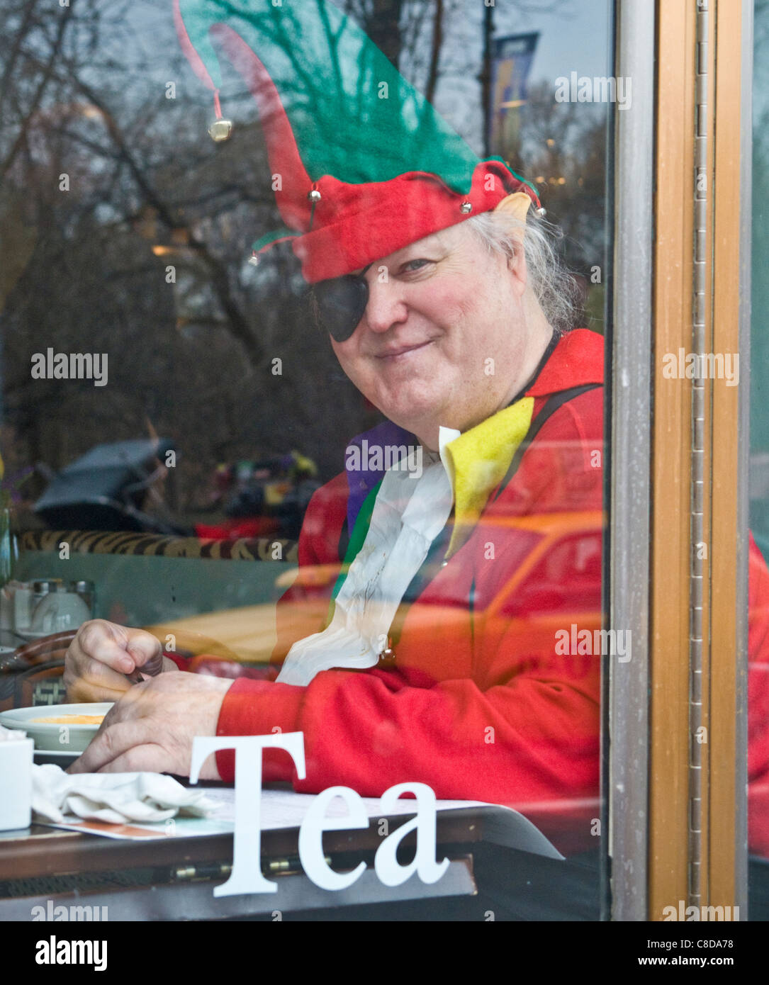 Santa claus Elf helper eating lunch in NYC restaurant window during ...