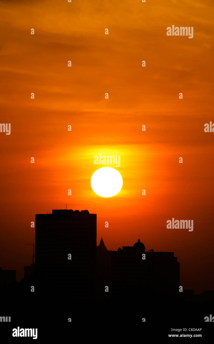 Sun Setting Behind Buildings High Resolution Stock Photography and ...