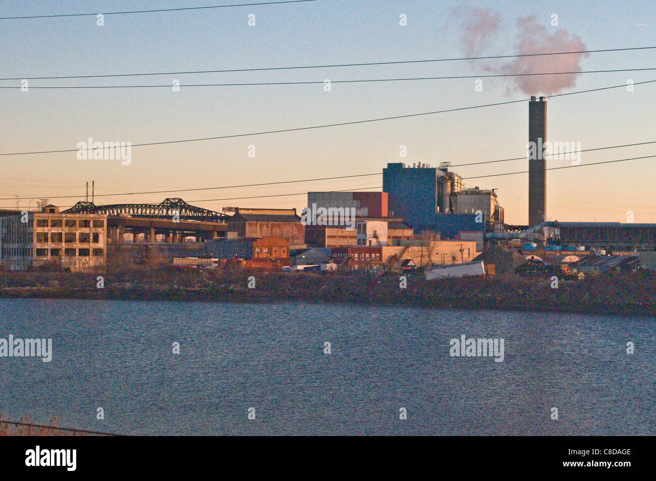 Industrial manufacturing building along river Stock Photo - Alamy