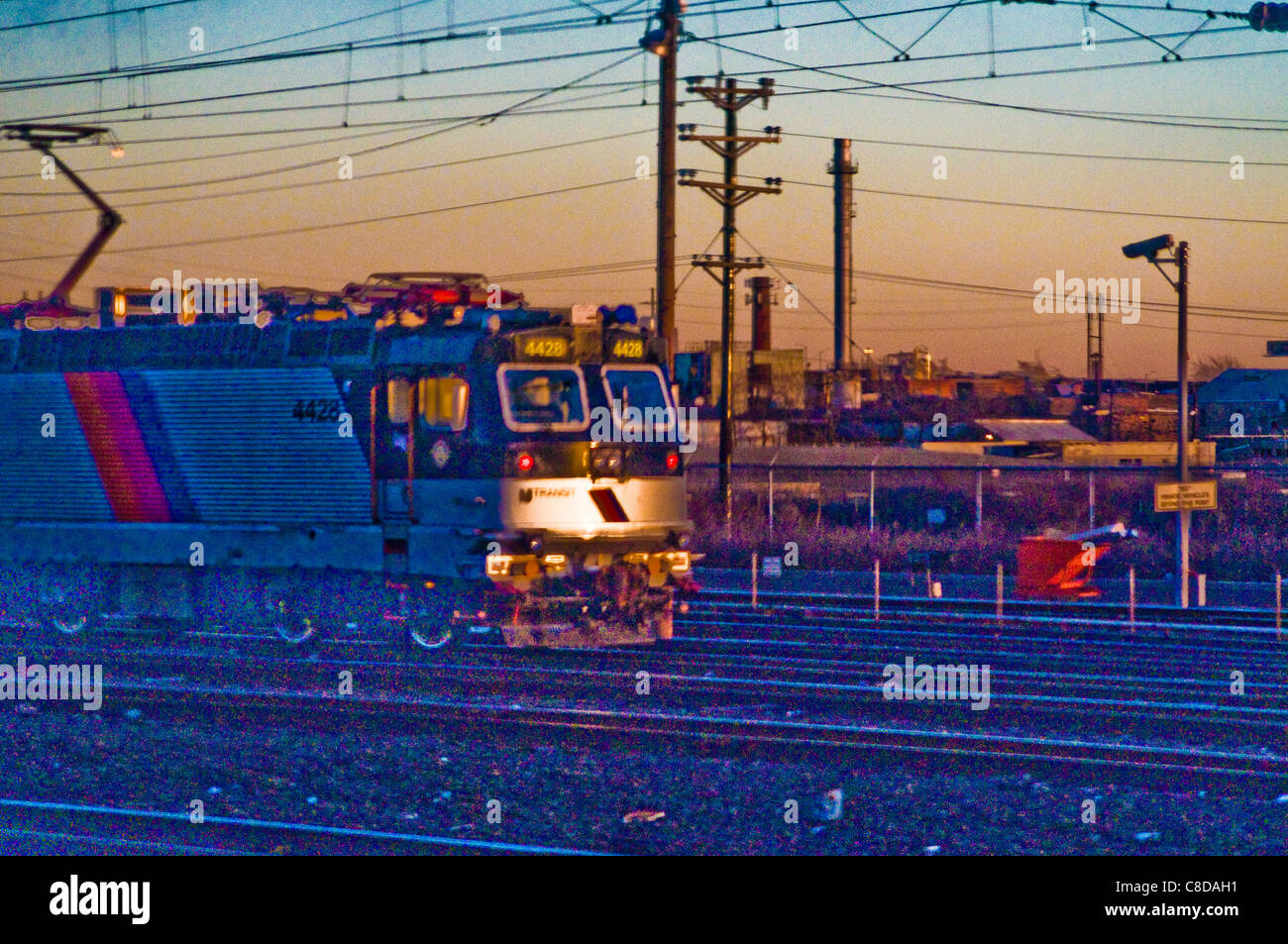 Commuter train engine. electric power lines. Symbolic Stock Photo - Alamy