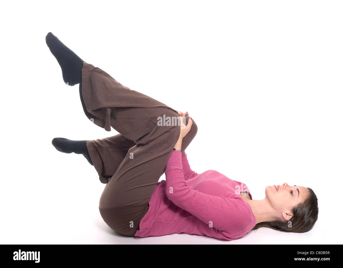 Caucasian woman lying on back and stretching legs Stock Photo - Alamy